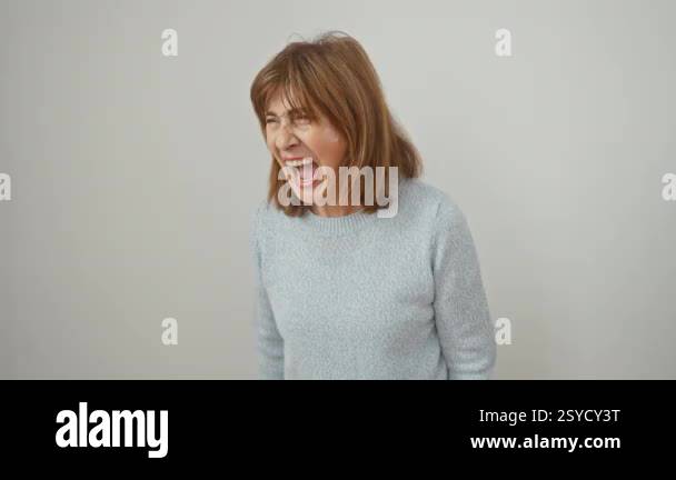Frustrated middle age female in sweater, screaming in furious rage and ...