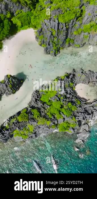 Boats and ocean waves in Hidden Beach. Matinloc Island. El Nido ...
