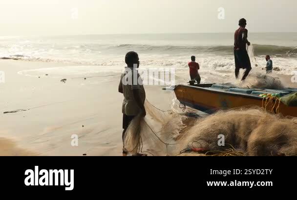 Group of Fishermen Lifting the boat out of the sea Kakinada Andhra ...