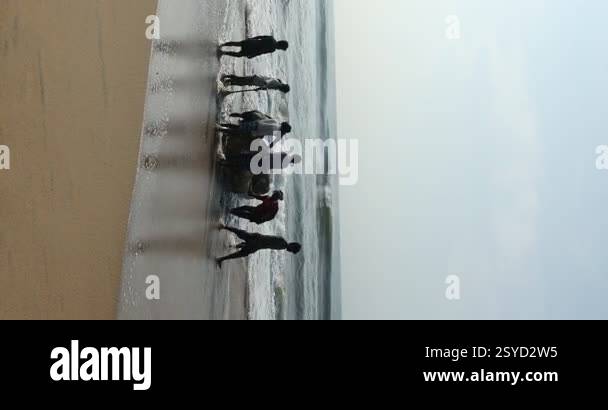Group of Fishermen Lifting the boat out of the sea Kakinada Andhra ...