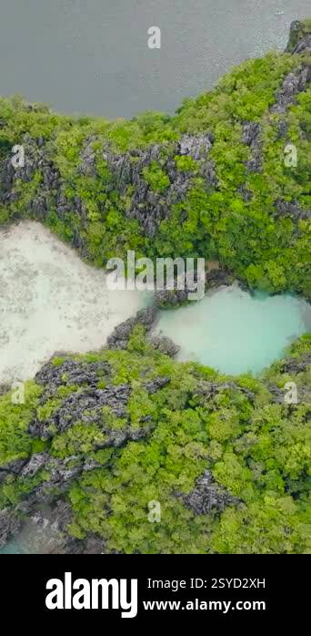 Aerial view of lagoons with boats surrounded by splendid limestone rock ...