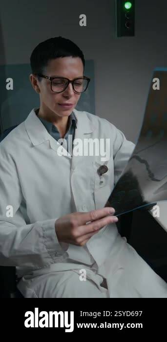 Medium vertical shot of focused middle-aged Caucasian female radiology ...