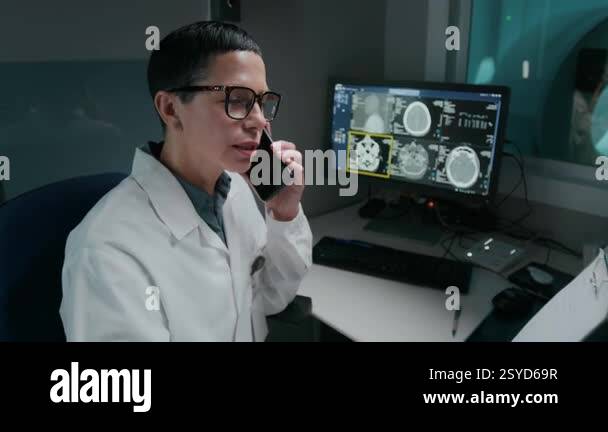 Medium zoom-out shot of Caucasian female radiology diagnostician ...
