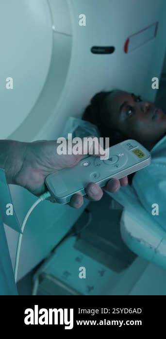 Vertical medium closeup of hand of nurse or radiology technologist ...