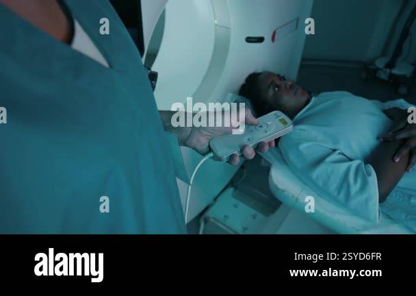 Medium full high-angle shot of hand of doctor pressing button on remote ...