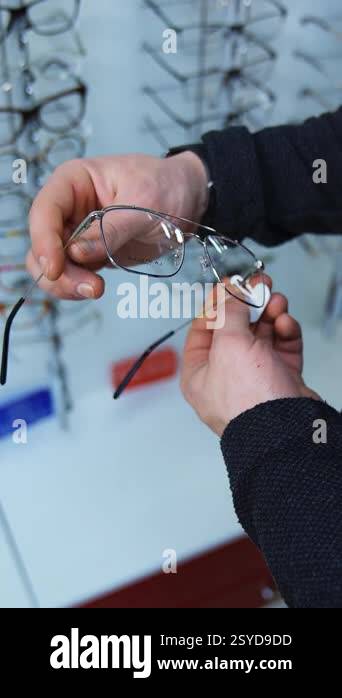 Client choosing lenses in store. Young male patient testing and trying ...