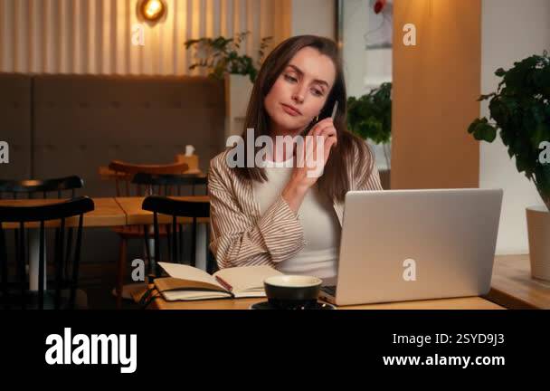 Multitasking busy working freelance distant work from cafe Caucasian cafeteria visitor woman ...