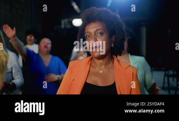 Focused woman in congregation during worship, emotional and reflective ...