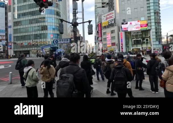 Pedestrians crossing at a bustling city junction Stock Video Footage ...