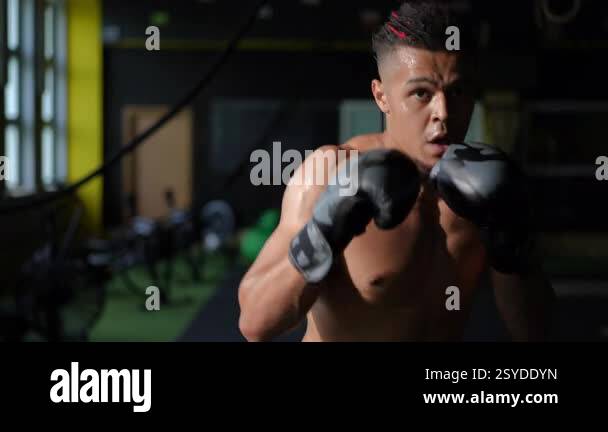 A highly determined boxer is training rigorously in a dynamic and ...