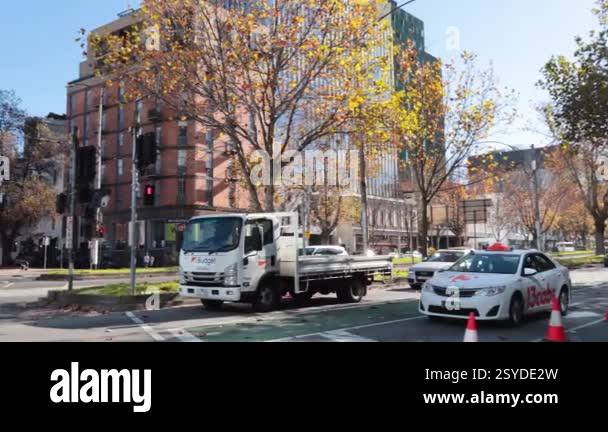 Vehicles navigating a busy Melbourne intersection Stock Video Footage ...