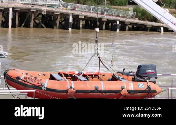 Lifeboat being lowered into the river Stock Video Footage - Alamy