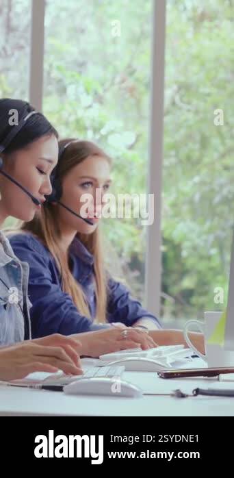 Customer support agent or call center with headset works on desktop ...
