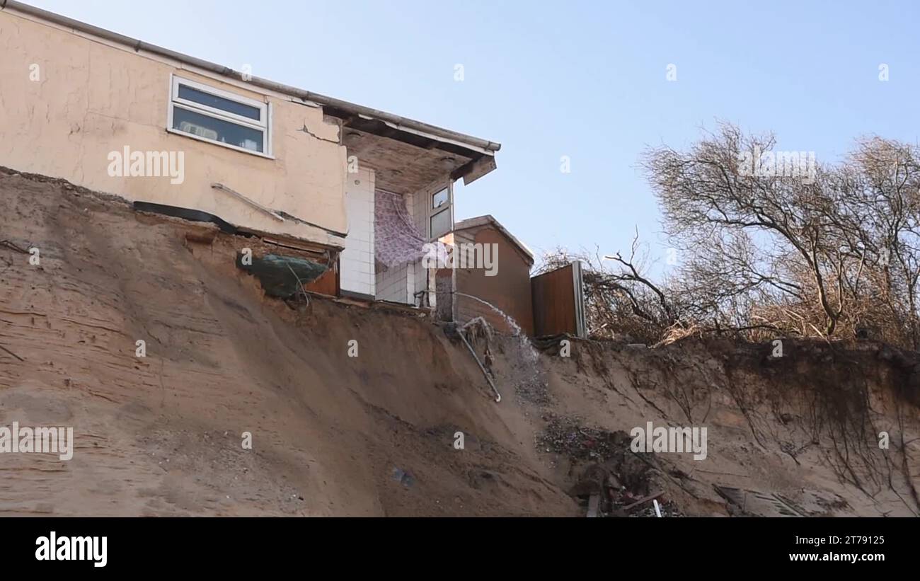 Ground footage of houses sitting on collapsed cliff edge Stock Video ...