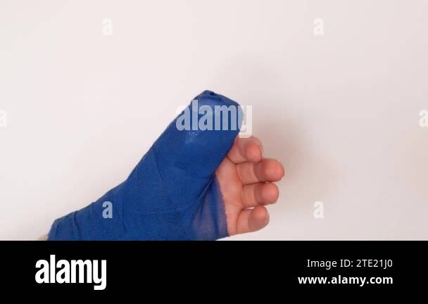Bandaged hand.Blue surgical bandage on the arm on a white background ...