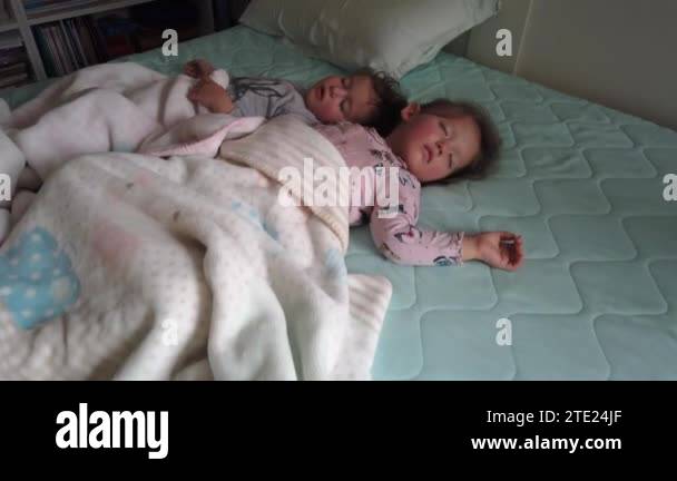 Two cute sisters toddler sleep. Little sisters sleeping in bed at home ...