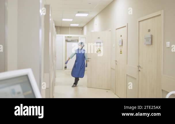 Girl doctor carries a radioactive capsule for the installation of an ...