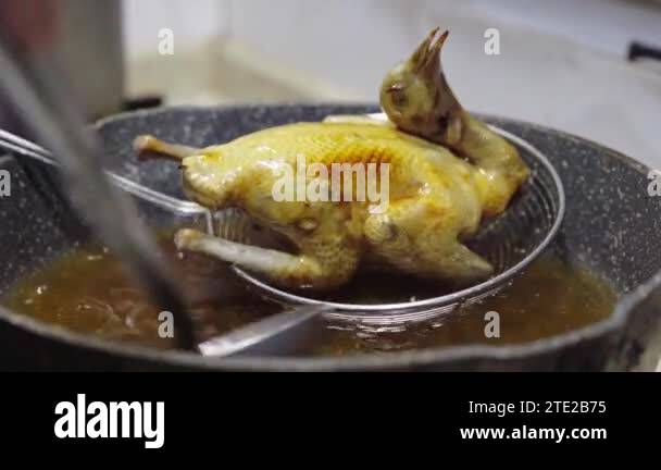A chef is making braised pigeon, fried pigeon, classic Cantonese ...