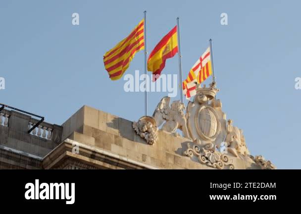 Flags of Spain and Catalonia on the roof of the historic city hall in ...