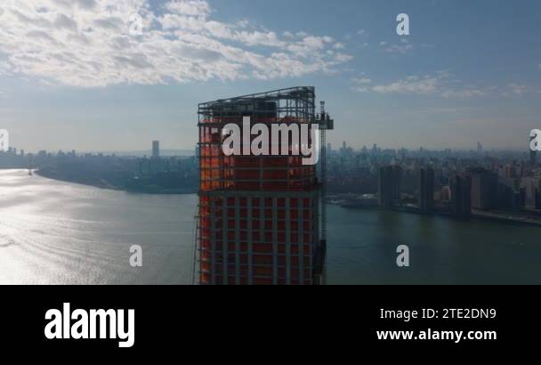 Orbit shot around top of skyscraper. High rise building on waterfront ...