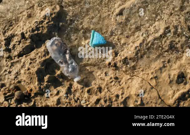 Plastic bottle and polystyrene debris discarded on contaminated sea ...