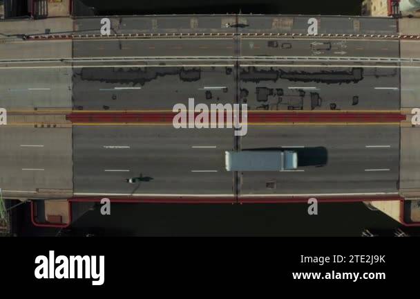 Aerial birds eye overhead top down ascending shot cars driving on ...