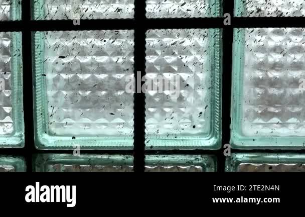 Dirty window of an abandoned building. Metal bars on the window of an ...