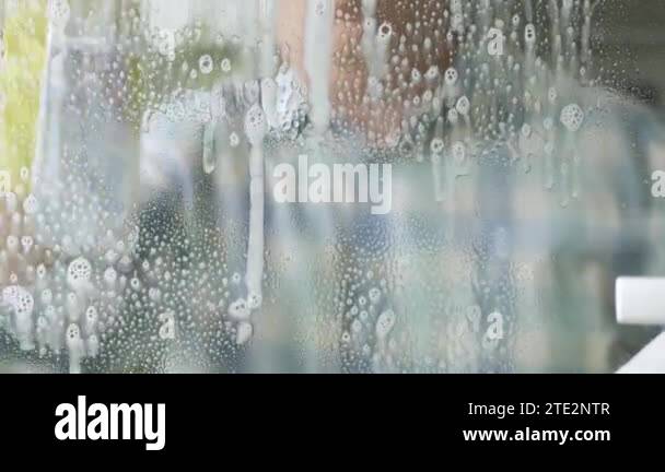 Man Washing and Cleaning a Double-Glazed Window at Home using ...