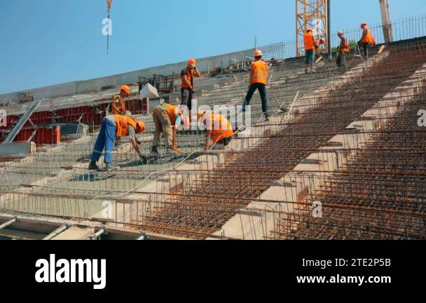 Working process at a construction site. Workers make a reinforced ...