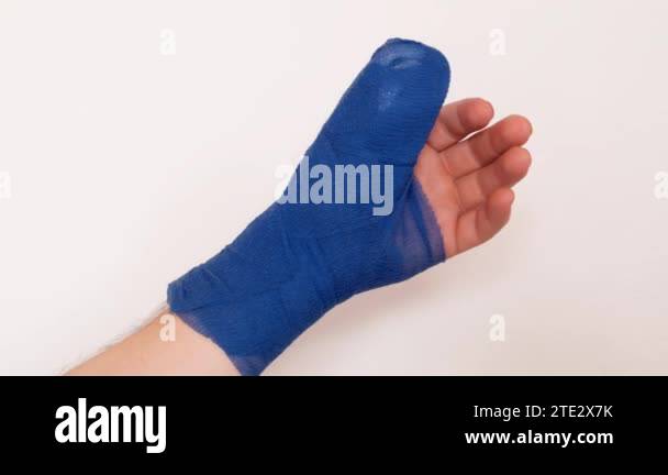 Bandaged hand.Blue surgical bandage on the arm on a white background ...