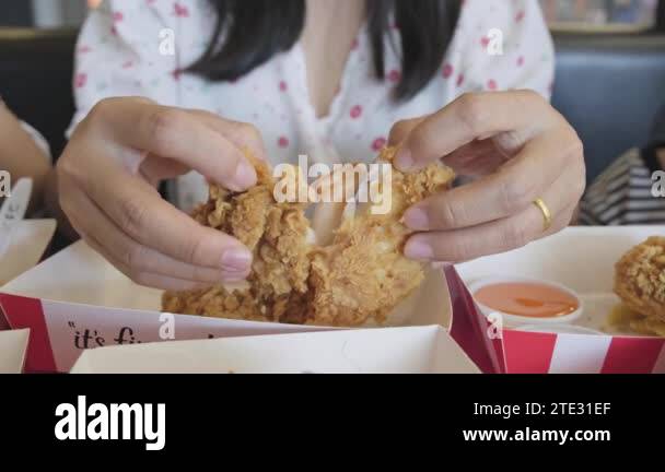 Close up of mother's hands holding KFC fried chicken with cute little ...