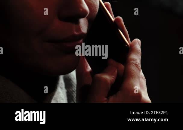 The woman is talking on the phone. Close-up of the lower part of the ...