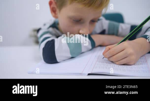 School boy practicing writing the alphabet at home. Boy child kid ...