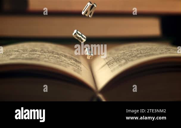 English letters fall on an open book. Filmed is slow motion 1000 frames ...
