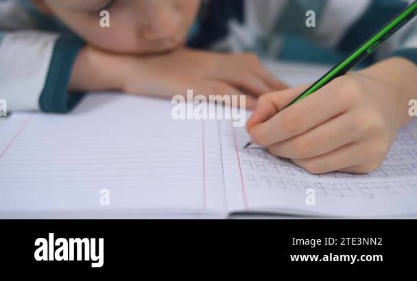 School boy practicing writing the alphabet at home. Boy child kid ...