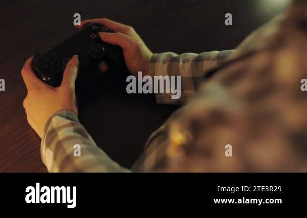 Beautiful excited young female gamer sitting on the couch playing and ...