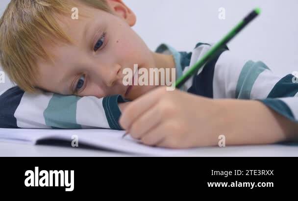 School boy practicing writing the alphabet at home. Boy child kid ...