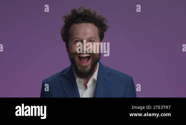 excited bearded man in suit holding fists up, celebrating, making crazy ...