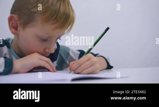 School boy practicing writing the alphabet at home. Boy child kid ...