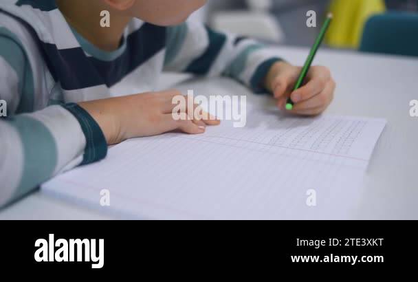 School boy practicing writing the alphabet at home. Boy child kid ...
