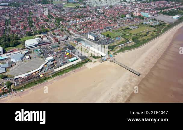 Static aerial footage of the town centre of Skegness showing the pier on the sandy beach near ...