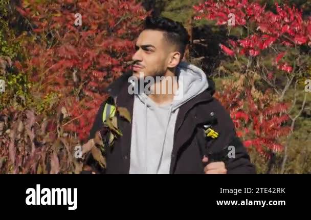 Hiking in autumn forest concept. Closeup Young active healthy Indian ...