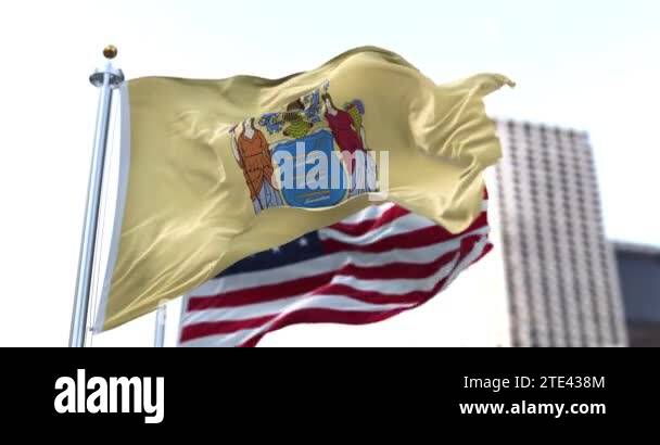the flag of the US state of New Jersey waving in the wind with the ...