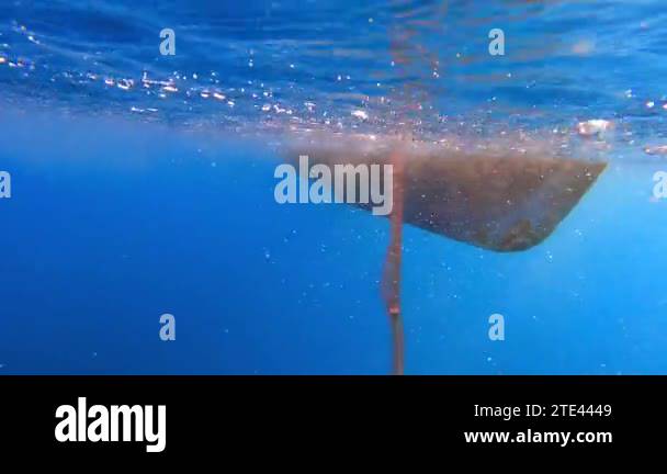 4K.Fishing net hanging from the boat under the sea.Underwater fishing ...