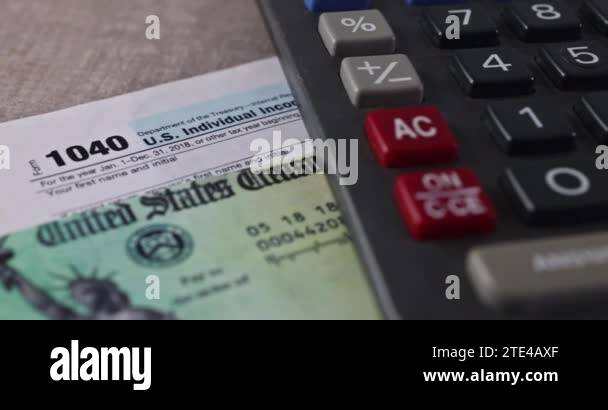 IRS form 1040 with individual income tax return of dollar bills of ...