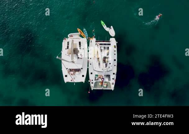 Two sailing catamarans together, two sailing ships moored together, top ...