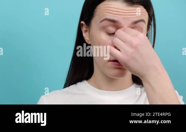 Young woman suffering from eyes pain and feeling something in eye ...