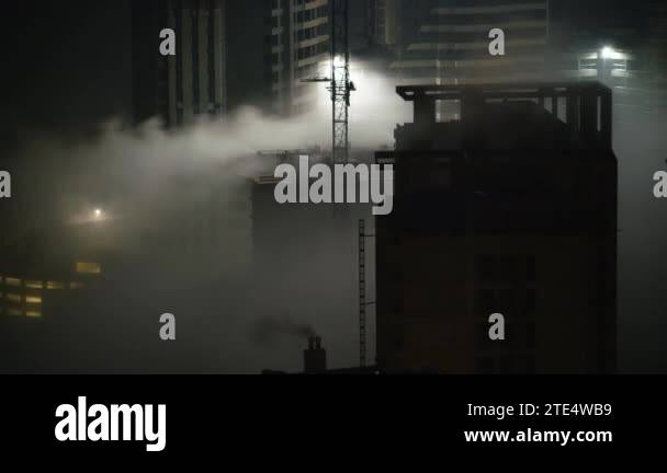 8K Night creepy and smoky construction site.Concrete and iron ...
