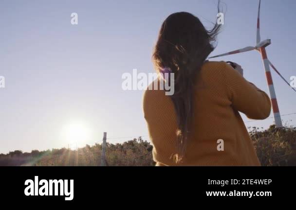 Filmmaker woman filming wind turbines Stock Video Footage - Alamy