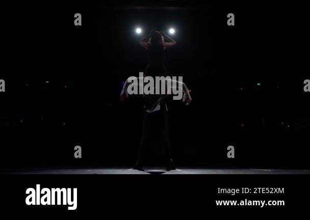 Woman dancer sits on mans shoulders,synchronous hand movements,flipping ...
